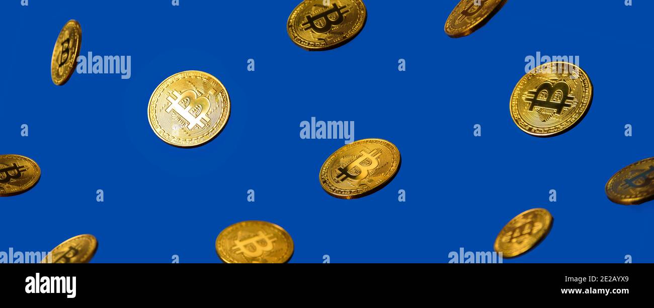 Many Bitcoins flying levitation on blue background - banner, wide ...