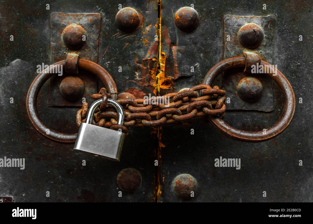 Old wooden door locked with rusty chain and padlock Stock Photo - Alamy
