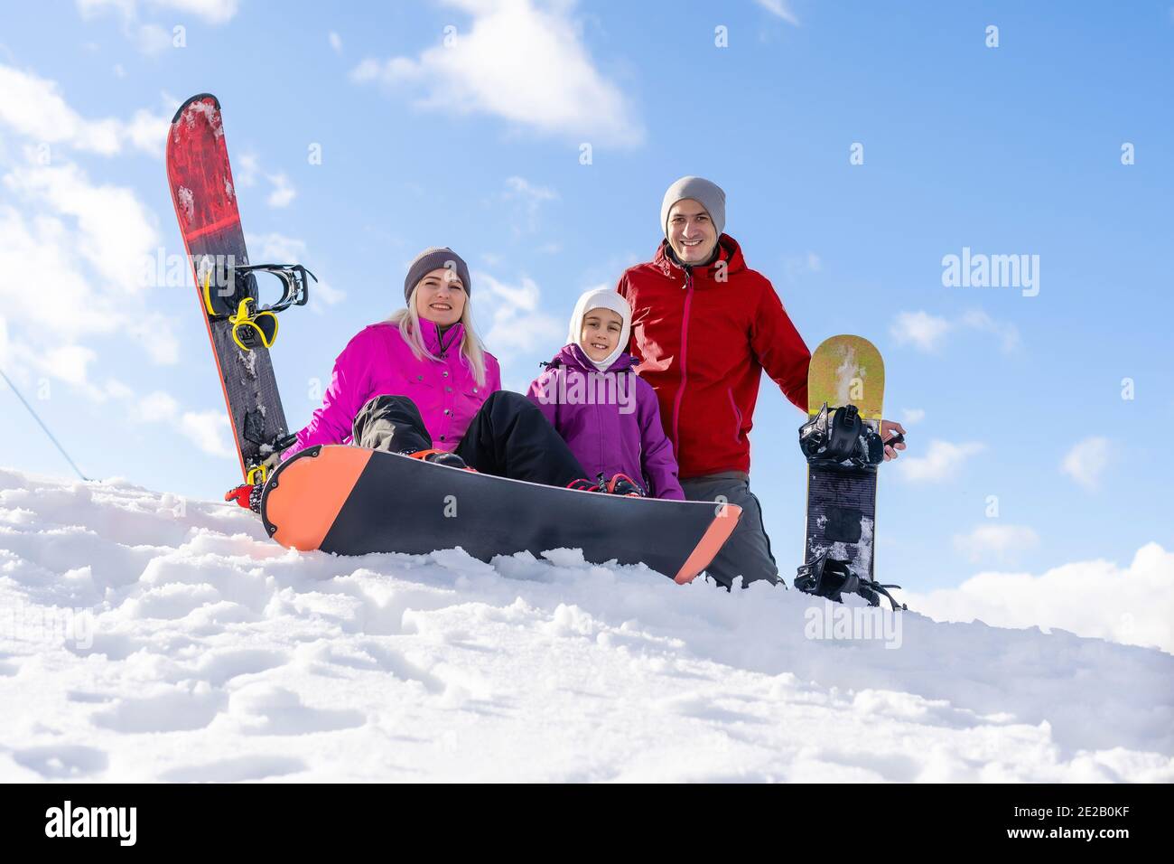 family with snowboards at winter resort Stock Photo - Alamy