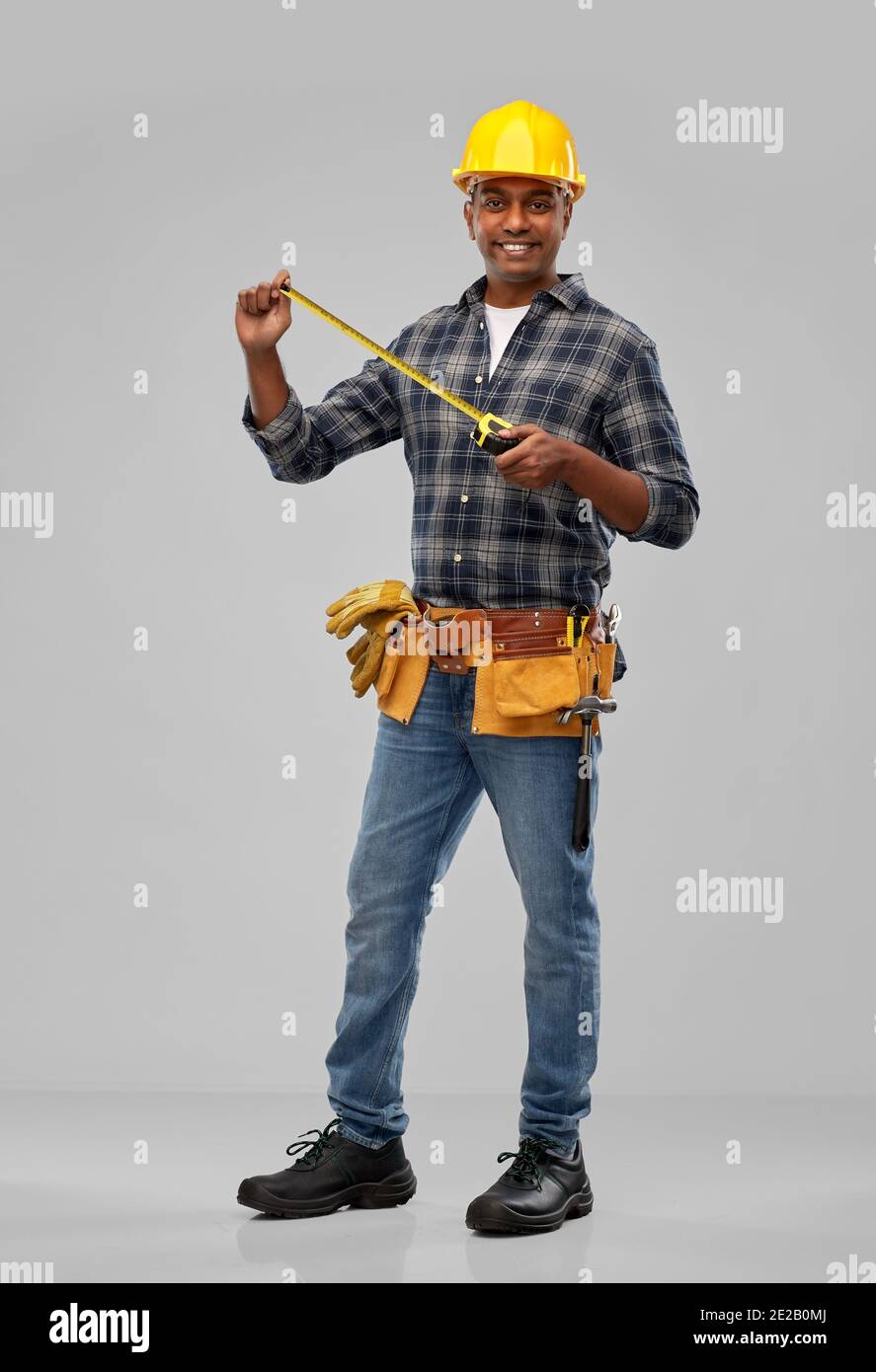 happy indian worker or builder with ruler Stock Photo - Alamy