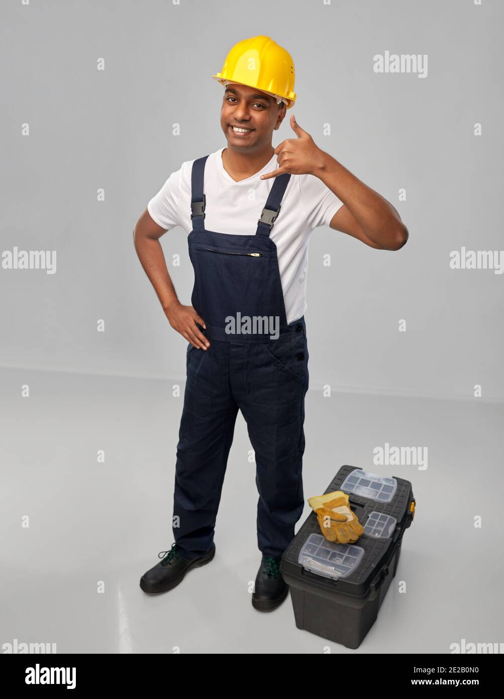 happy worker or builder making phone call gesture Stock Photo - Alamy