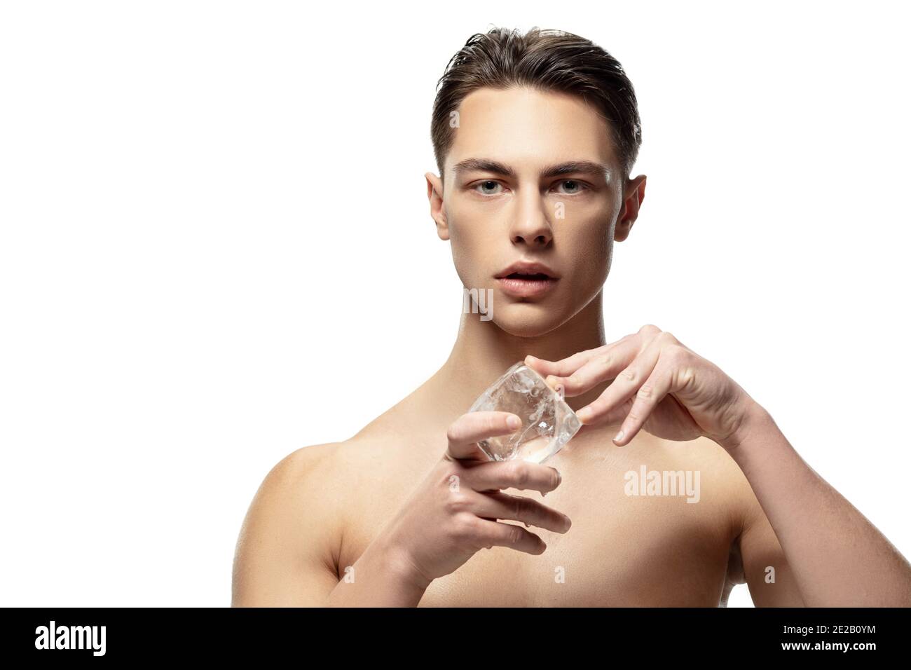 Cold. Portrait of young man isolated on white studio background ...