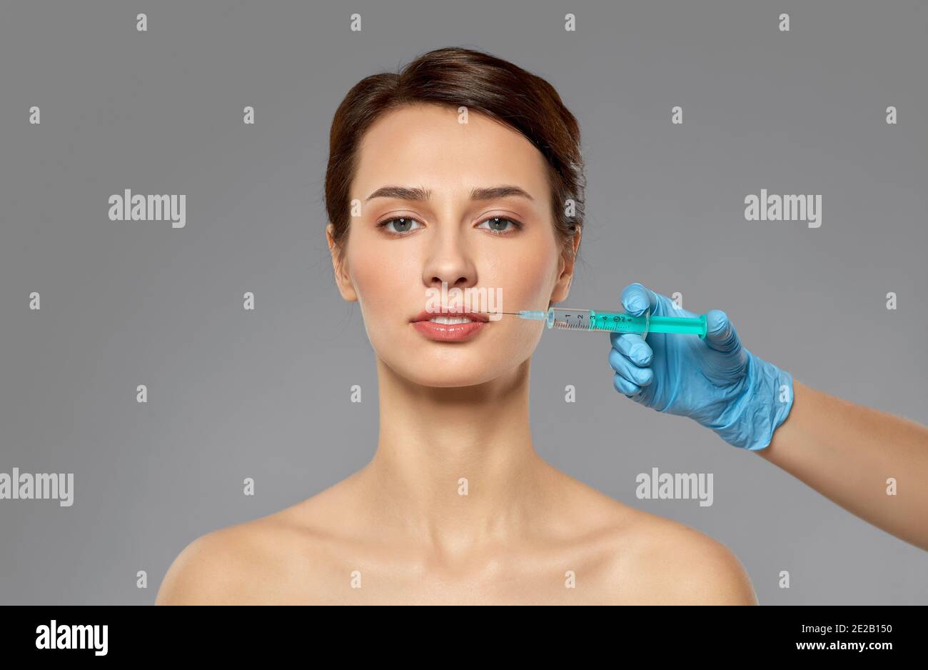 beautiful young woman and hand with syringe Stock Photo - Alamy