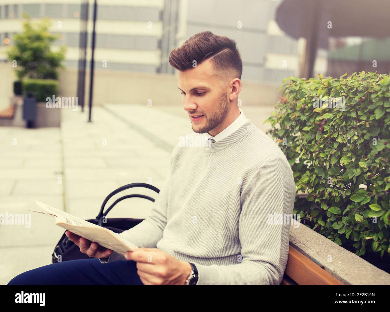 Man reading paper on bench hi-res stock photography and images - Alamy