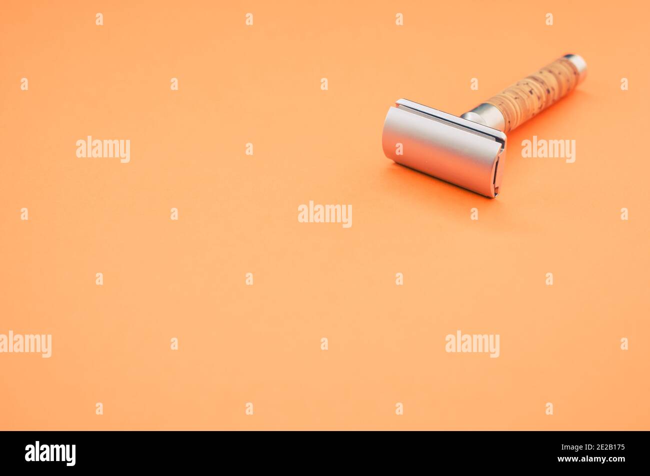 T shaped shaving razor on an orange background Stock Photo - Alamy