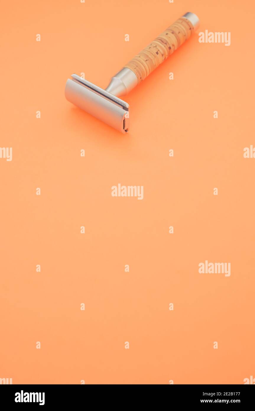 Vertical shot of a t shaped shaving razor on an oran background Stock ...