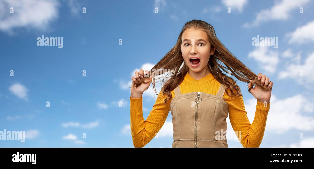scared young teenage girl holding her hair strands Stock Photo - Alamy
