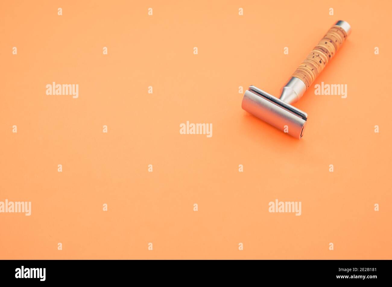 T shaped shaving razor on an orange background Stock Photo - Alamy