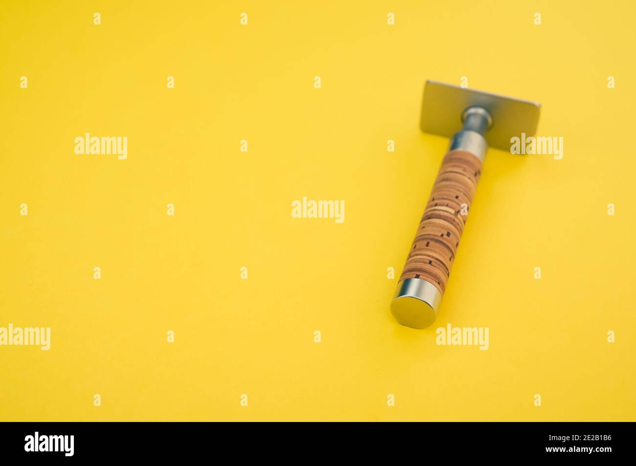 T shaped shaving razor on a yellow background Stock Photo - Alamy