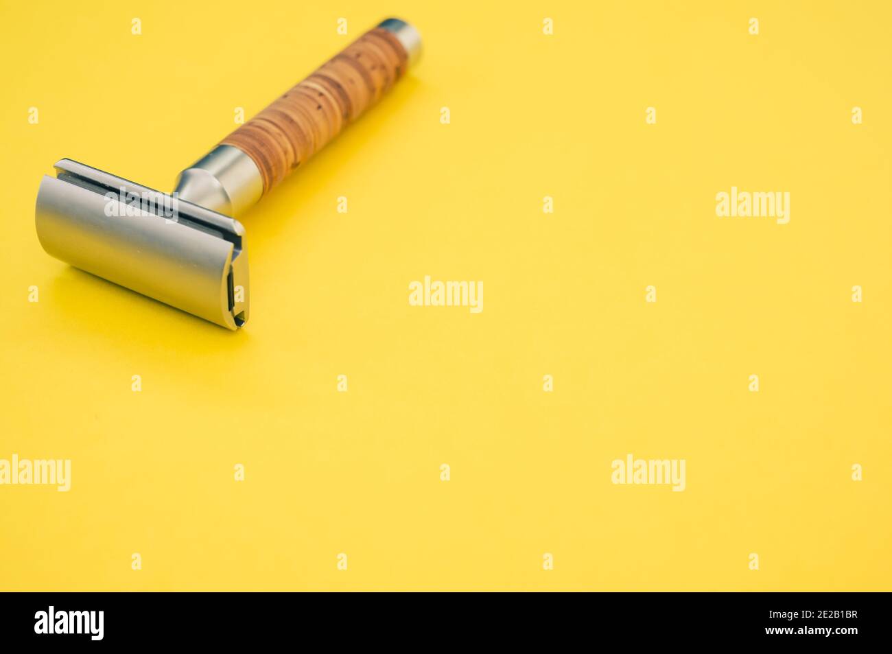 T shaped shaving razor on a yellow background Stock Photo - Alamy