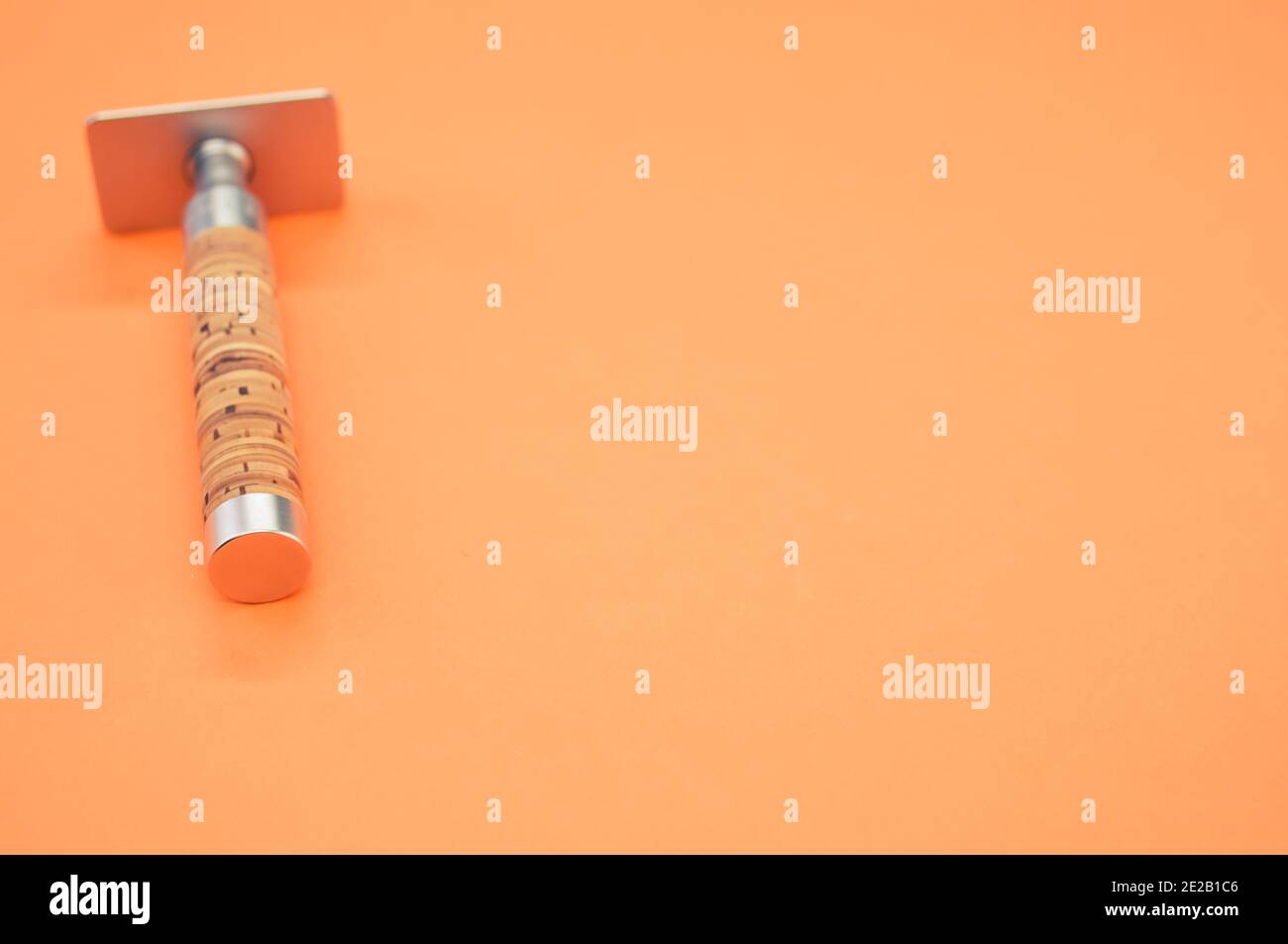 T shaped shaving razor on an orange background Stock Photo - Alamy