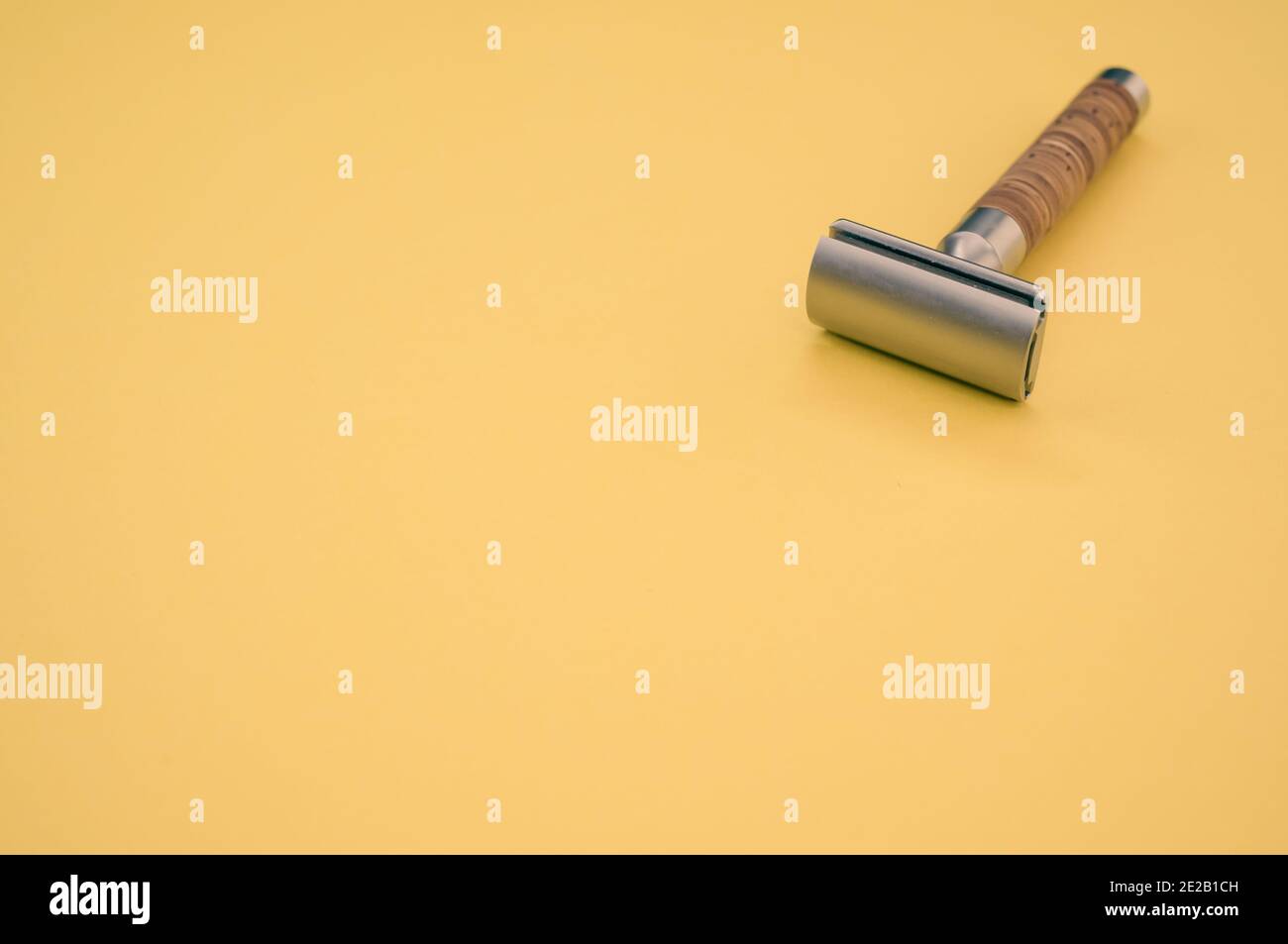 T shaped shaving razor on a yellow background Stock Photo - Alamy