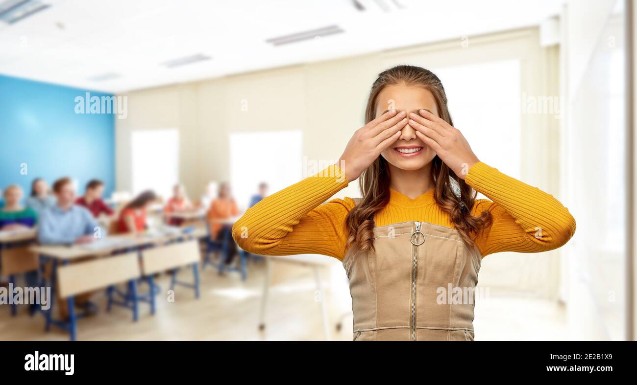 smiling student girl closing her eyes by hands Stock Photo - Alamy