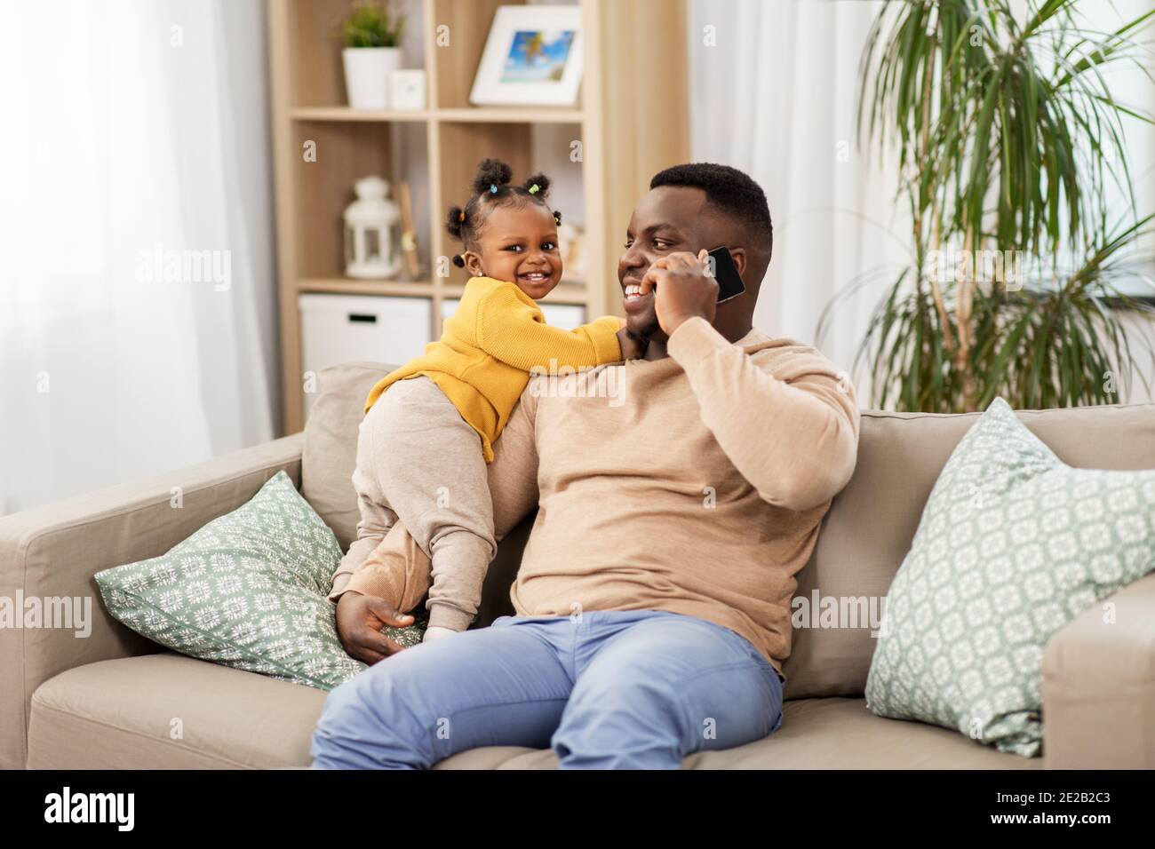 father with baby at home calling on smartphone Stock Photo - Alamy