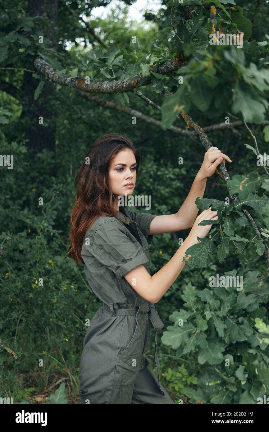 Portrait of a woman Holding hands on a tree branch green leaves travel ...