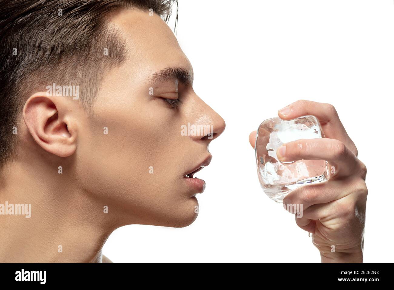 Cold heart. Portrait of young man isolated on white studio background ...