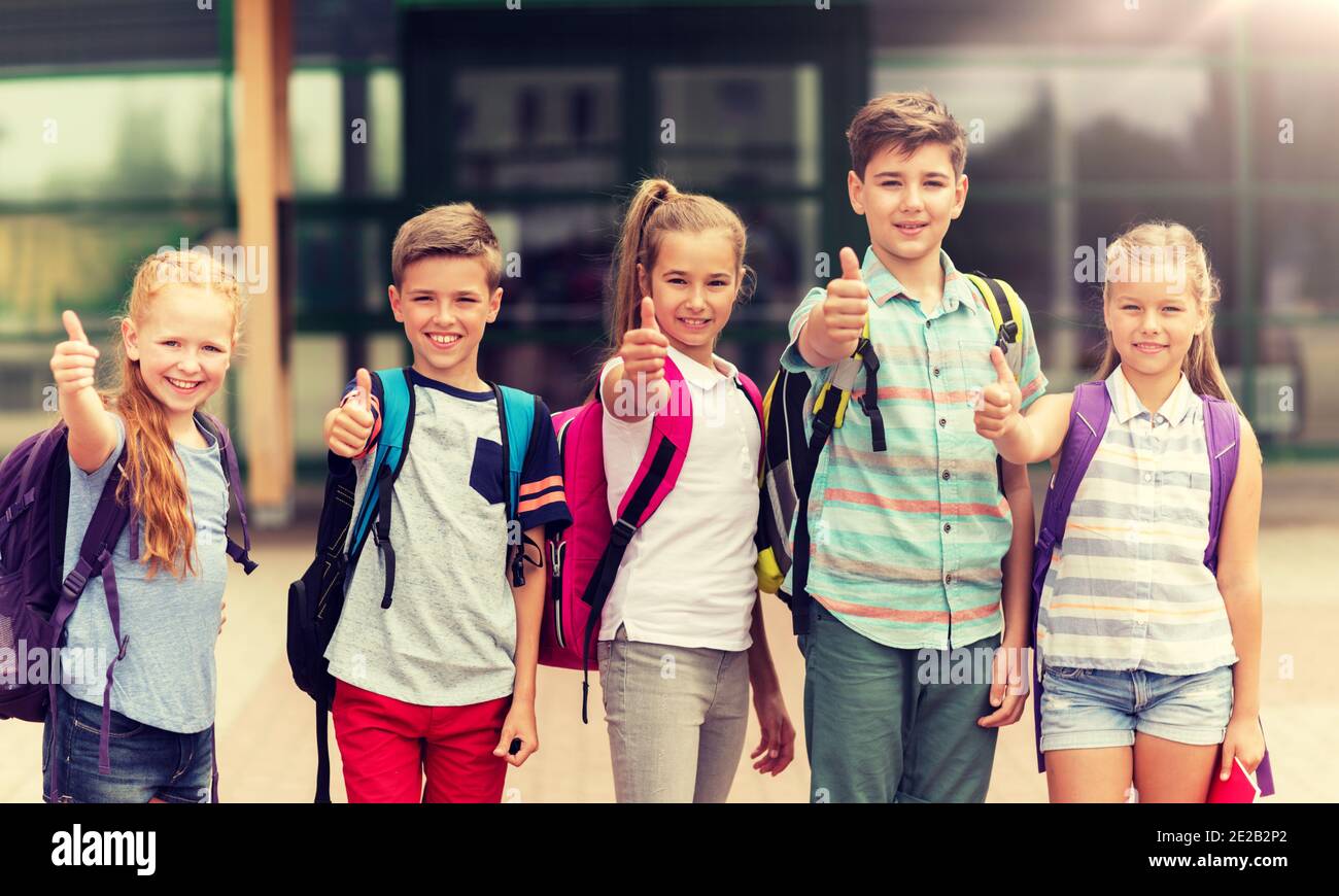 happy elementary school students showing thumbs up Stock Photo - Alamy