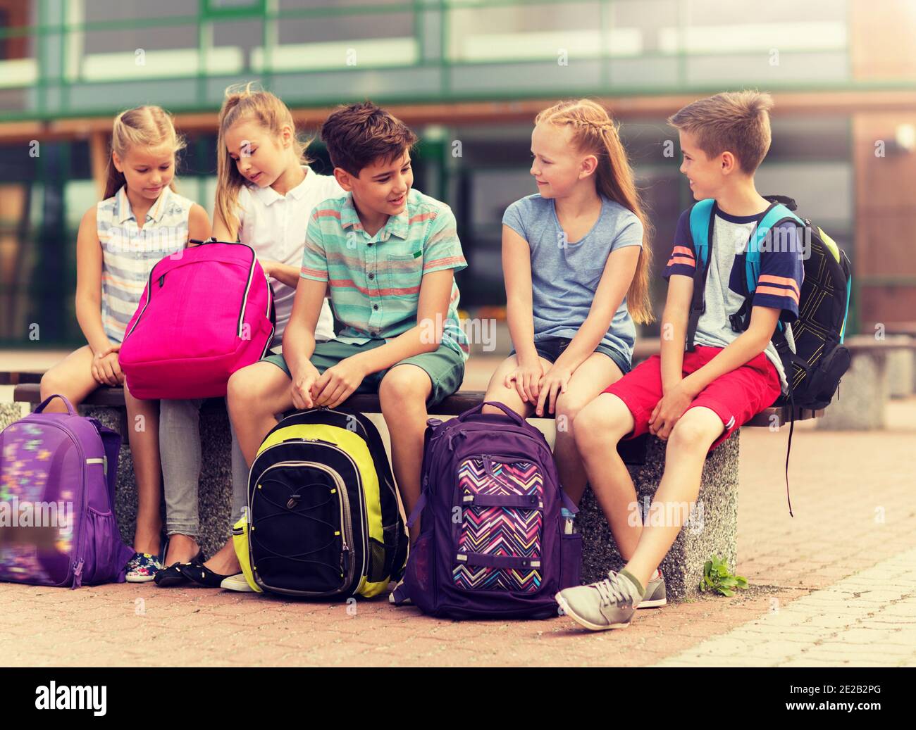 group of happy elementary school students talking Stock Photo - Alamy