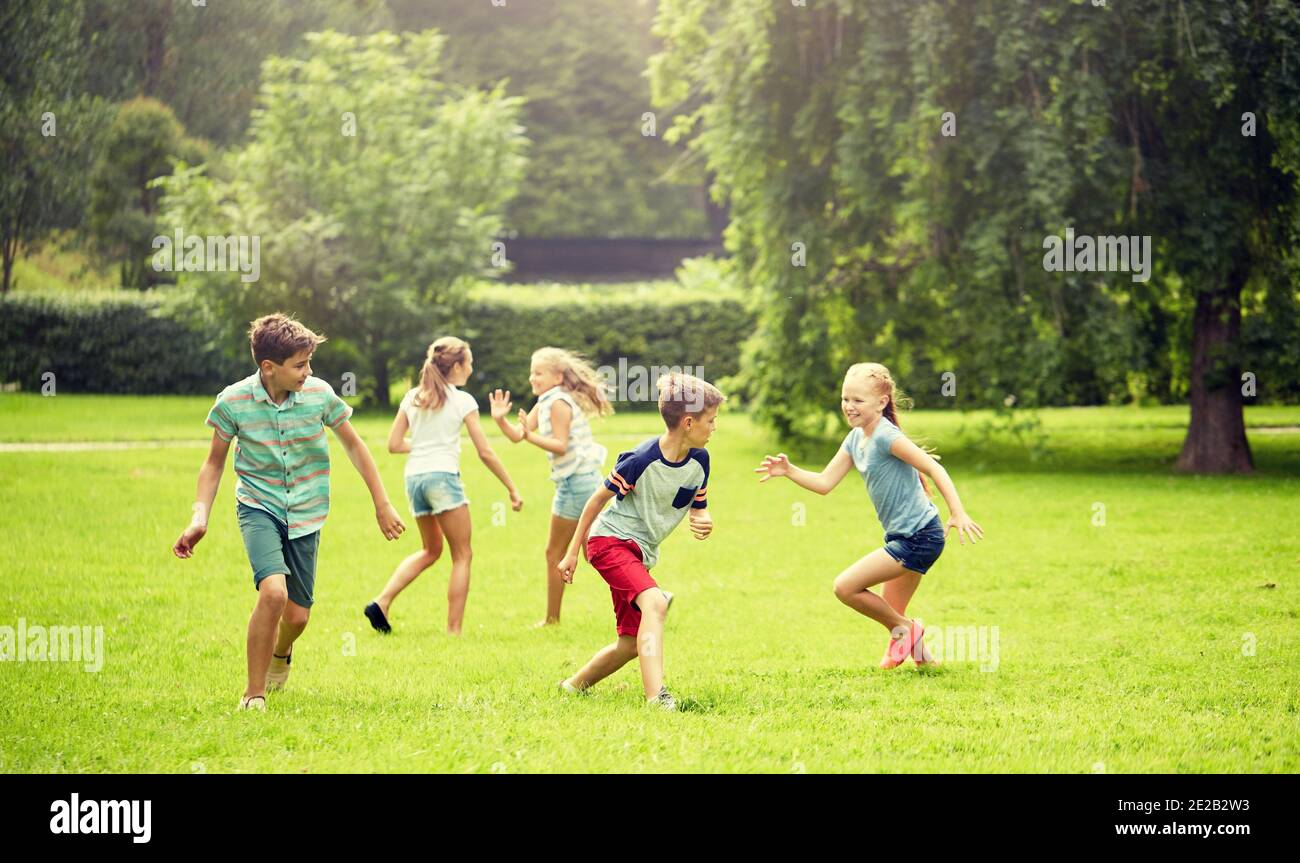 happy kids running and playing game outdoors Stock Photo - Alamy
