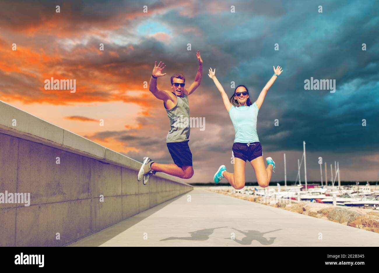 Woman jumping on pier in hi-res stock photography and images - Alamy