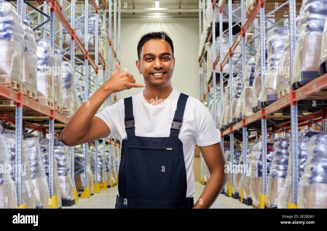 worker making phone call gesture at warehouse Stock Photo - Alamy