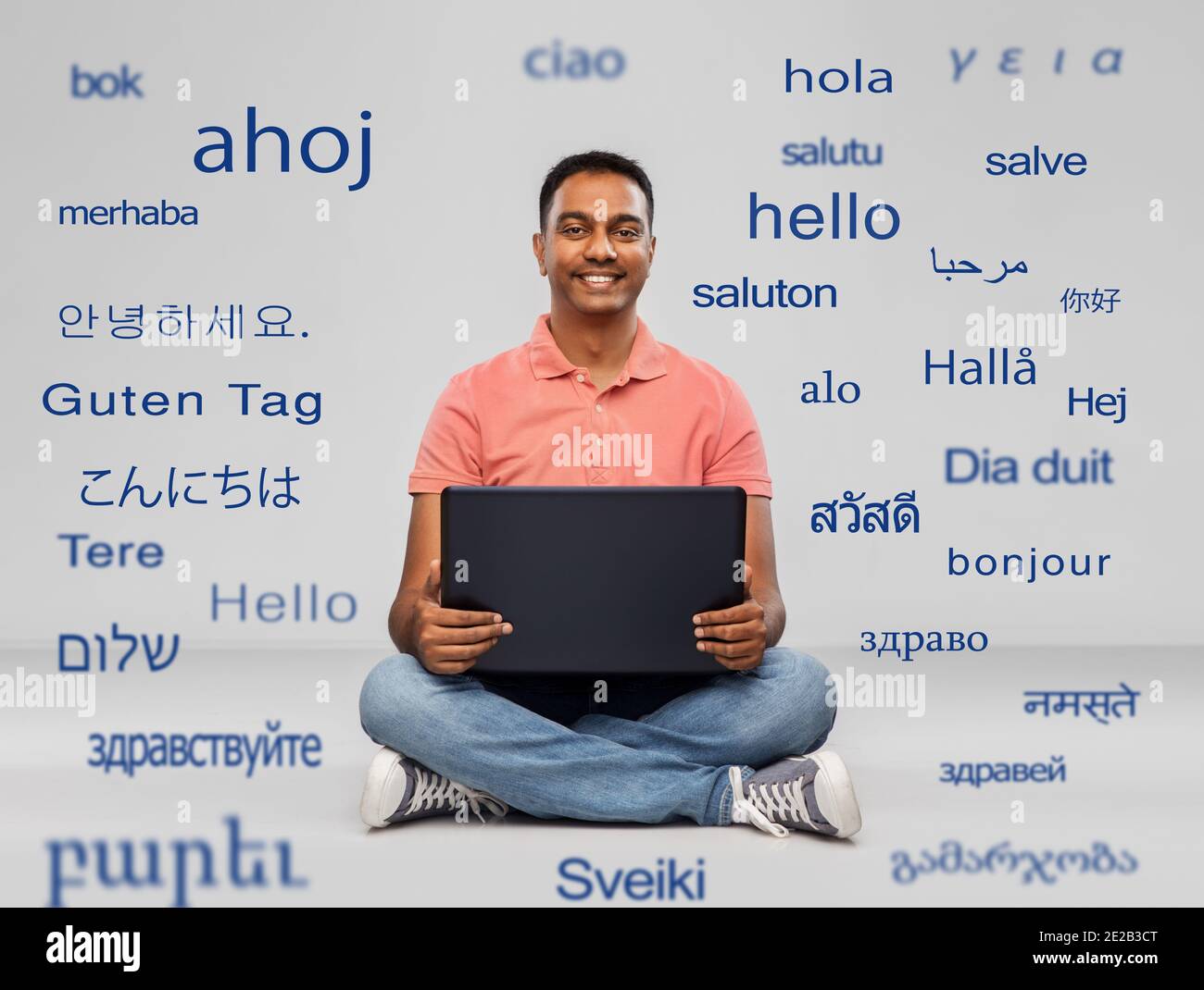 happy indian man with laptop computer on floor Stock Photo - Alamy