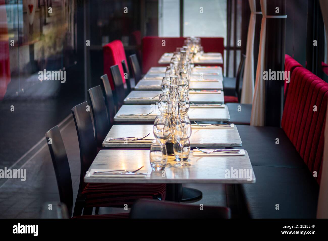 Row of empty restaurant tables with chairs Stock Photo - Alamy