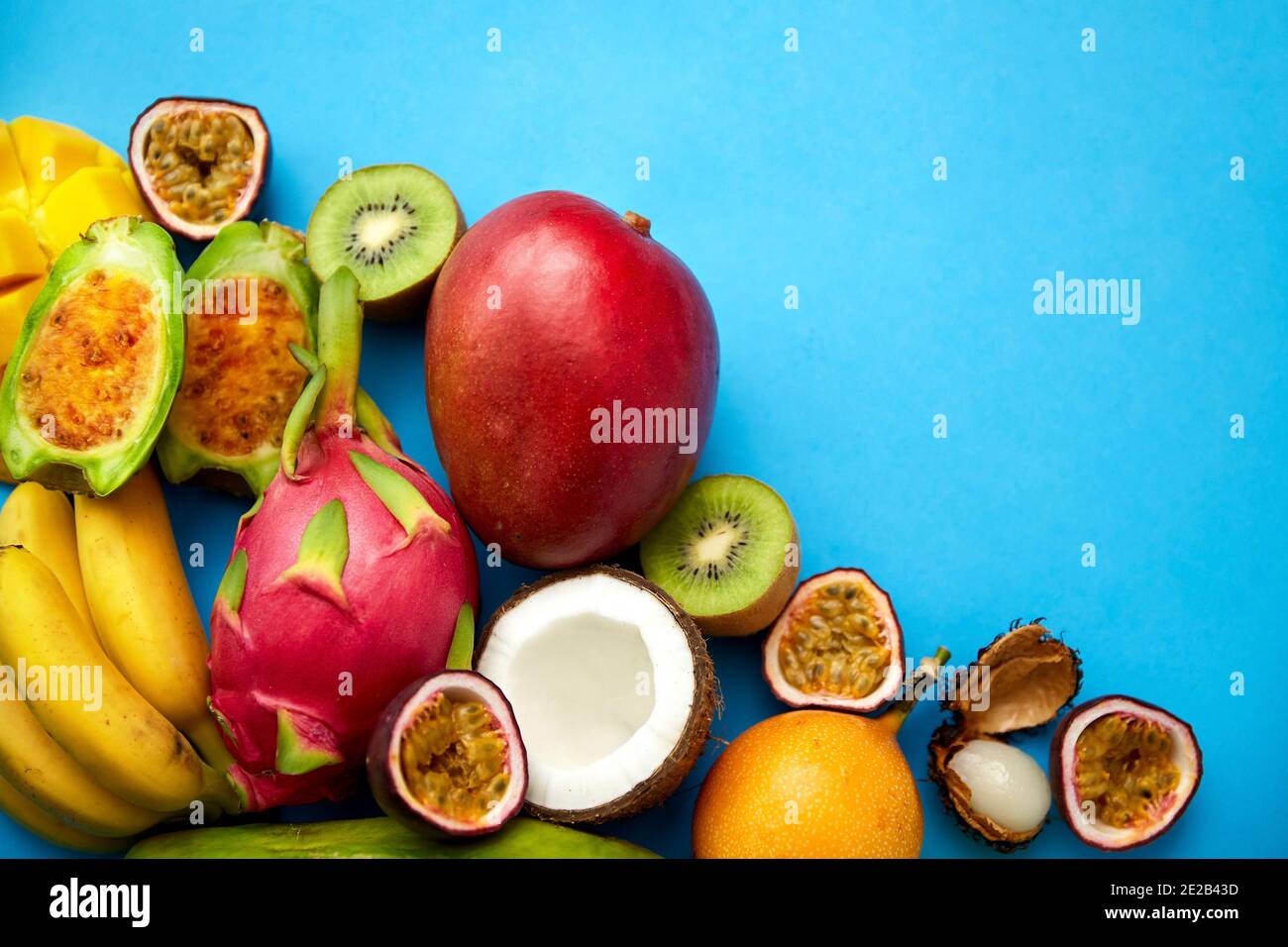 different exotic fruits on blue background Stock Photo - Alamy
