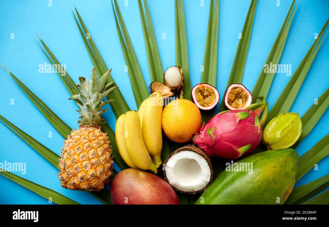 different exotic fruits on blue background Stock Photo - Alamy