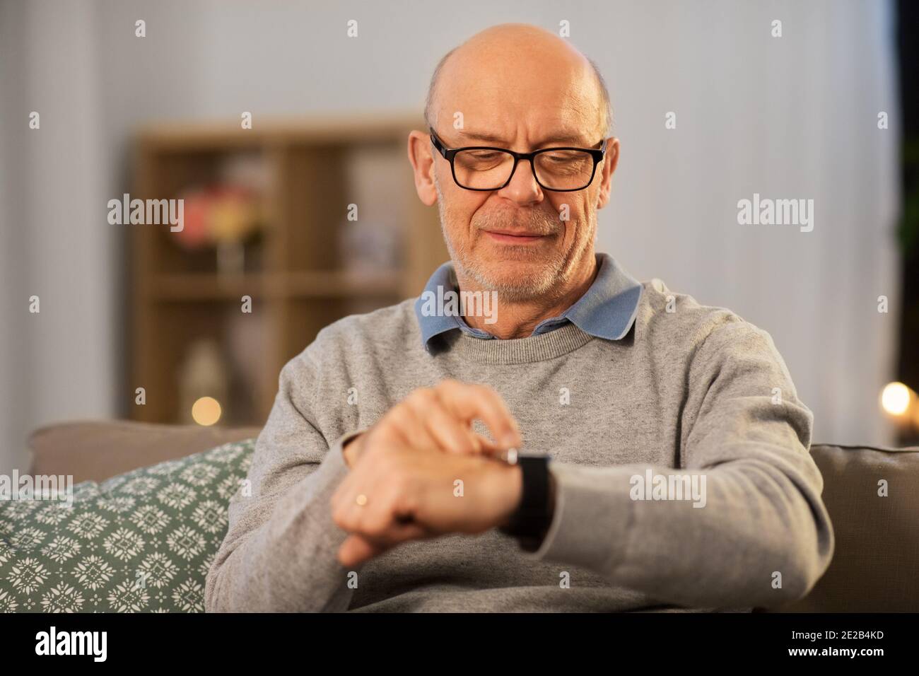 Looking at smartwatch home hi-res stock photography and images - Alamy