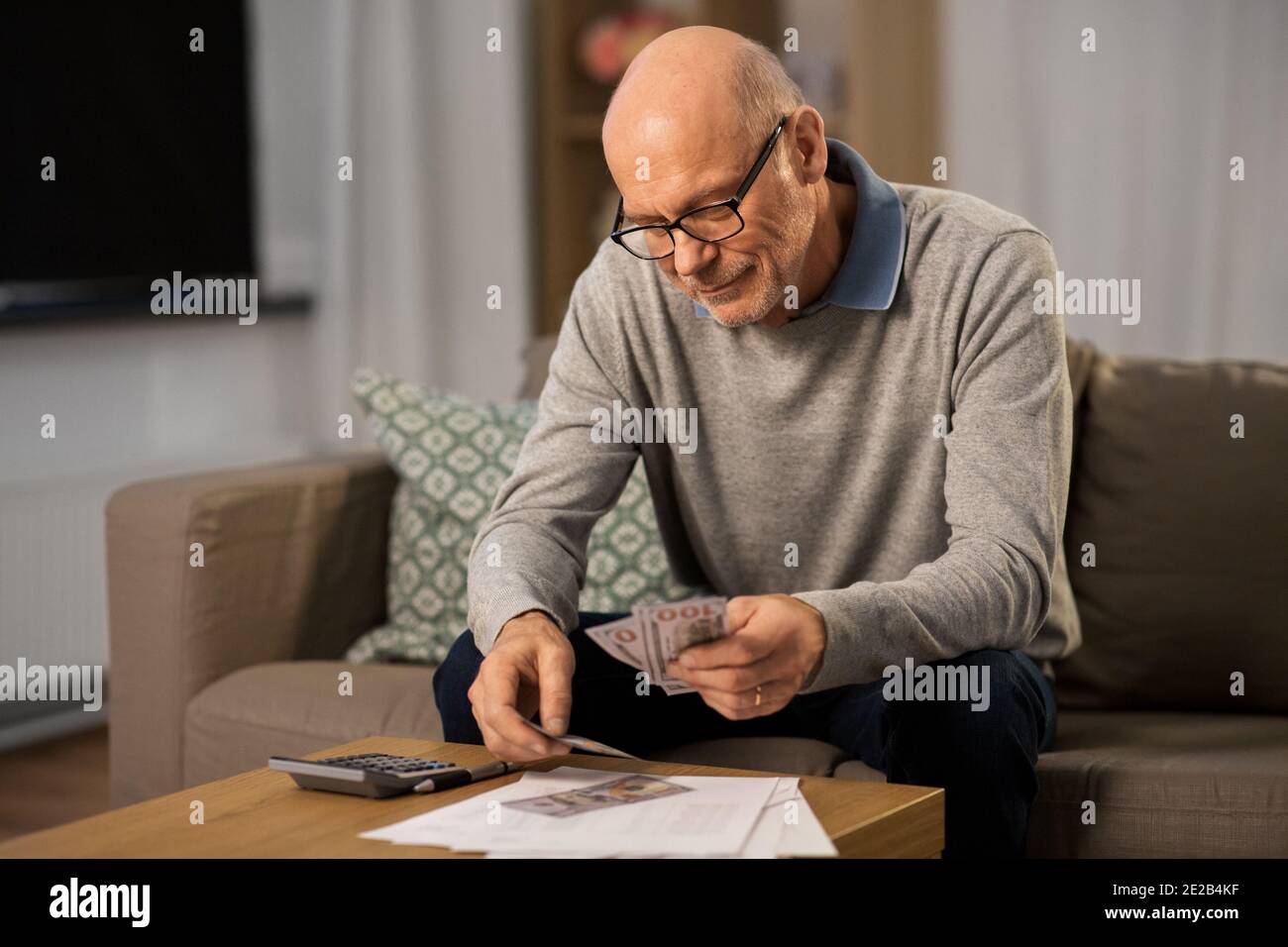 Old man saving money hi-res stock photography and images - Alamy