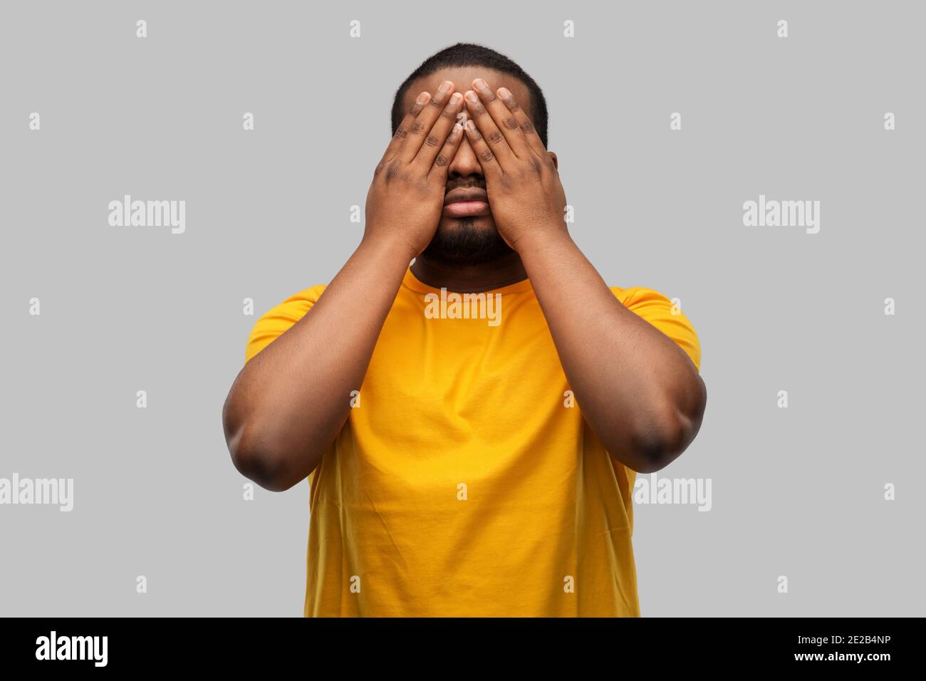 african american man closing his eyes by hands Stock Photo - Alamy