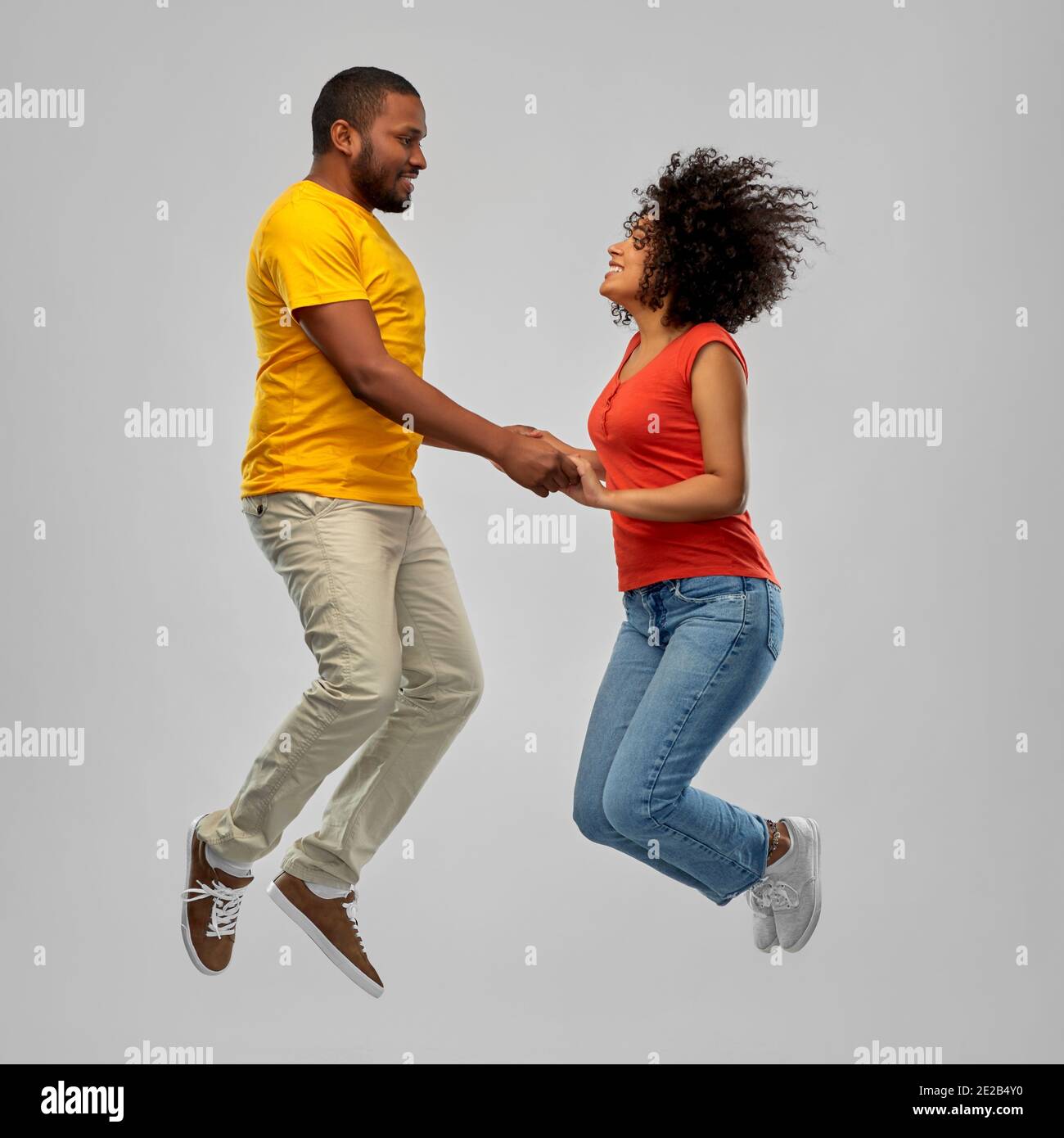 happy african american couple jumping in air Stock Photo - Alamy