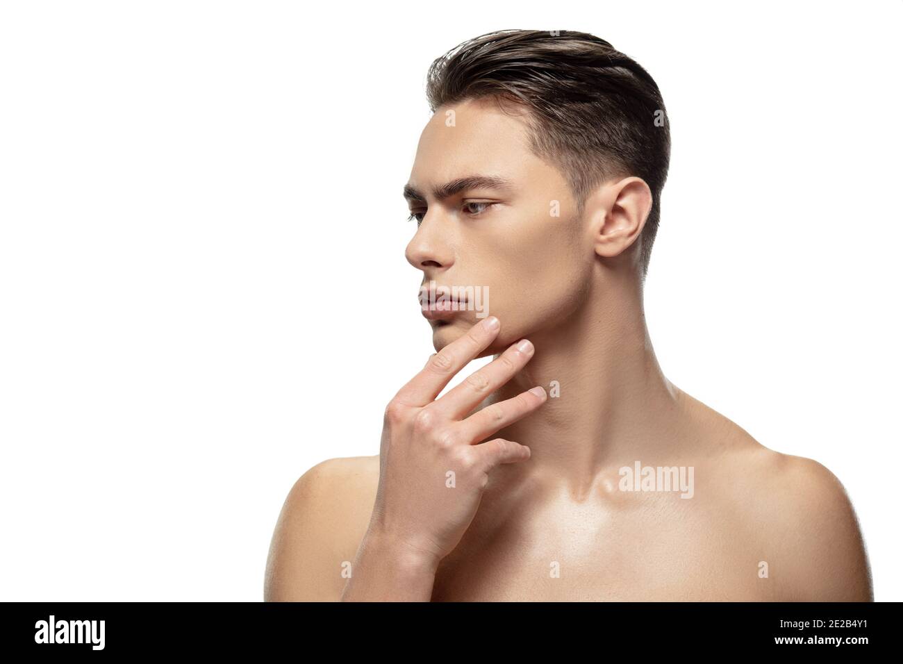 Thoughtful. Portrait of young man isolated on white studio background ...