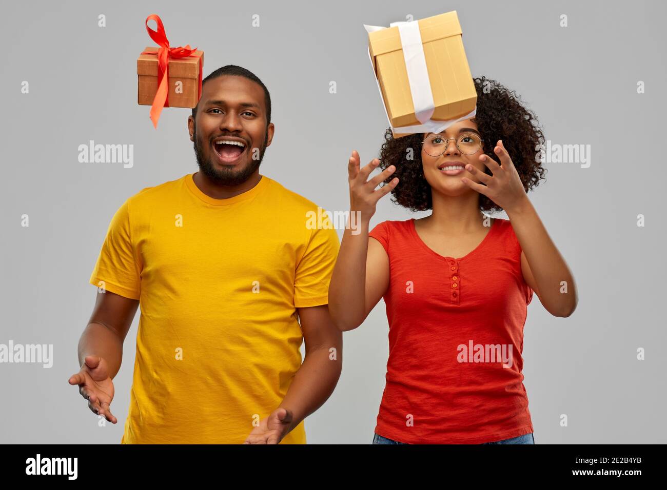 happy african american couple throwing gift boxes Stock Photo - Alamy
