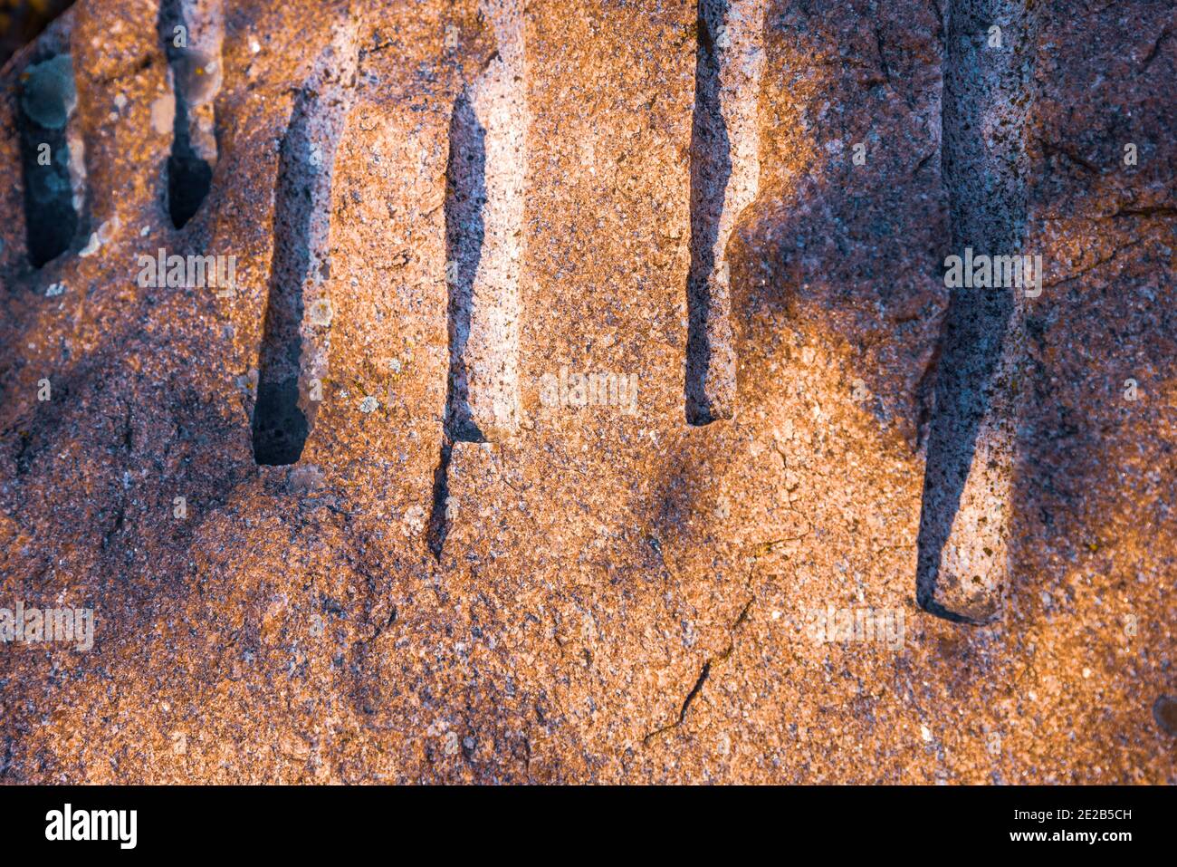 Unusual light stone with small protrusions traces in the bright sun in ...