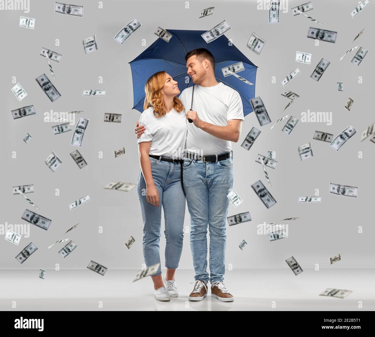 happy couple with umbrella standing money rain Stock Photo - Alamy