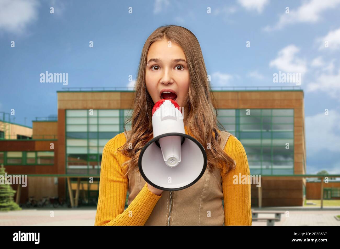 teenage girl speaking to megaphone over school Stock Photo - Alamy