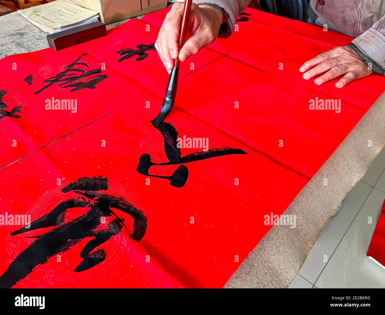 A calligrapher is creating and writing Spring Festival couplets ...