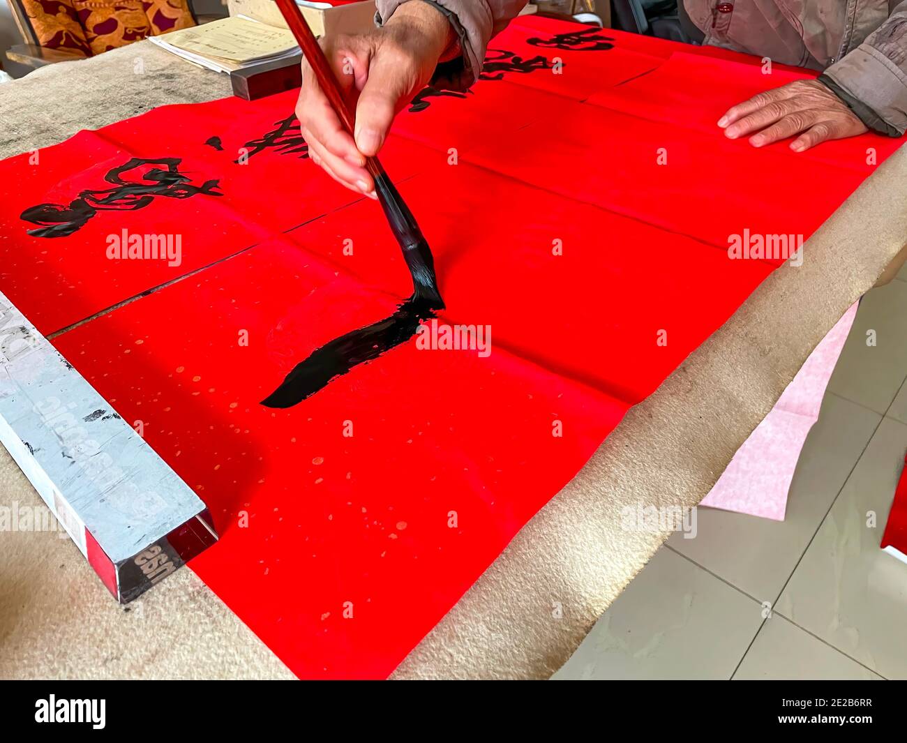 A calligrapher is creating and writing Spring Festival couplets ...