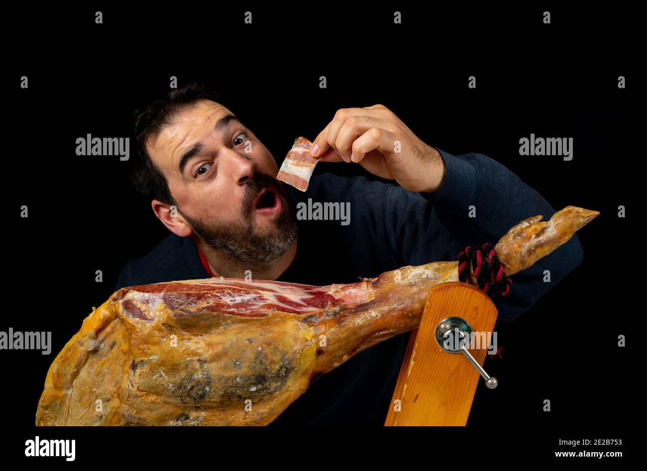 Bearded man with a ham knife ready to cut a piece of typical Spanish ...