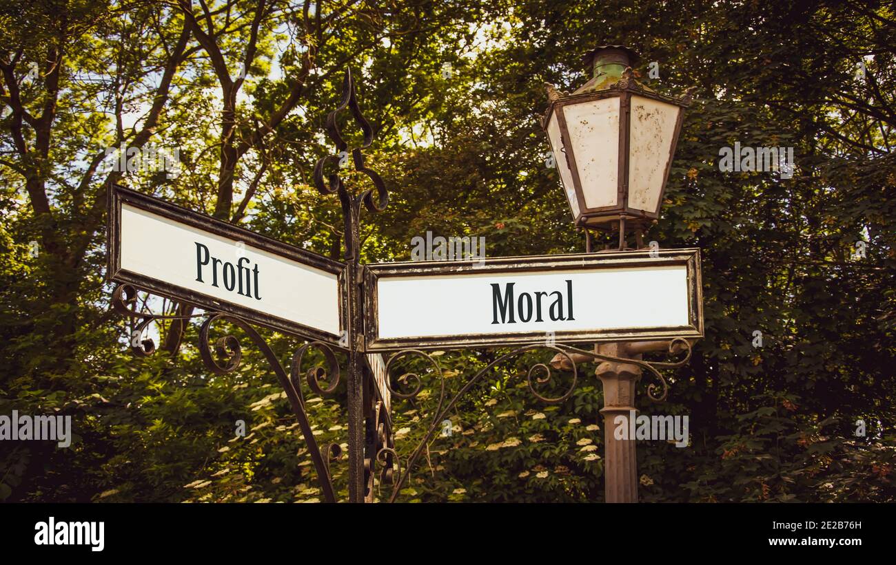 Street Sign the Direction Way to Moral versus Profit Stock Photo - Alamy