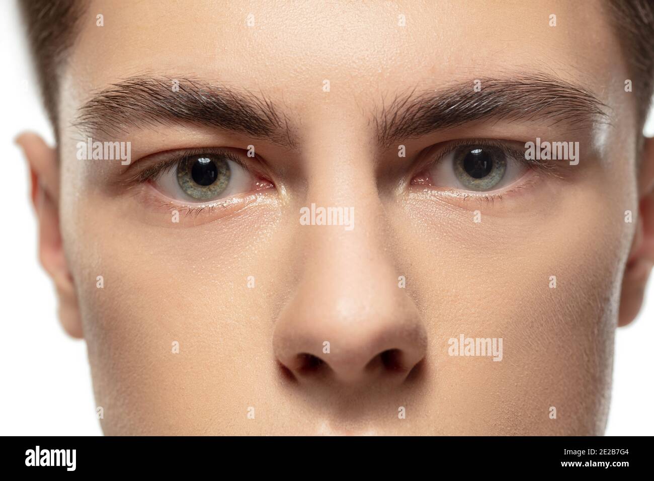 Eyes calm. Close up face of young man on white studio background ...