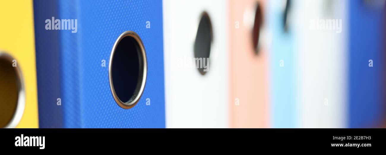 Stack of multi-colored folders is on the table Stock Photo - Alamy
