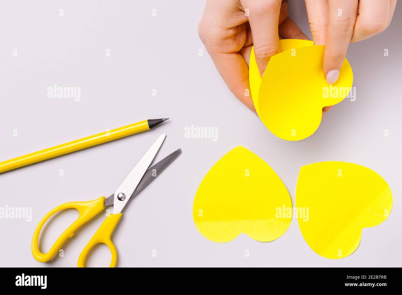 Illuminating stickers in the shape of hearts, female hands, pencil and ...