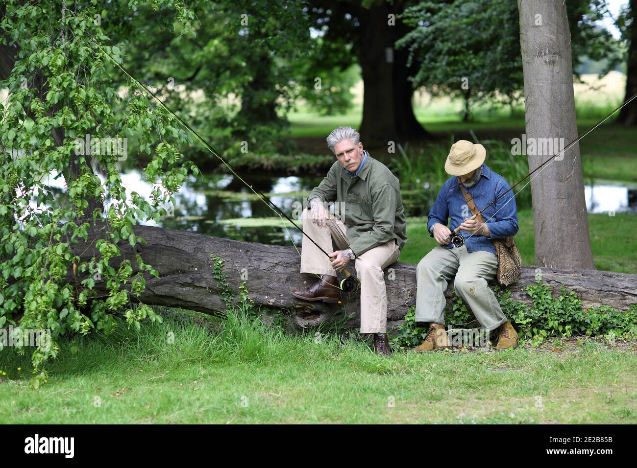 Two male friends fishing together Stock Photo - Alamy