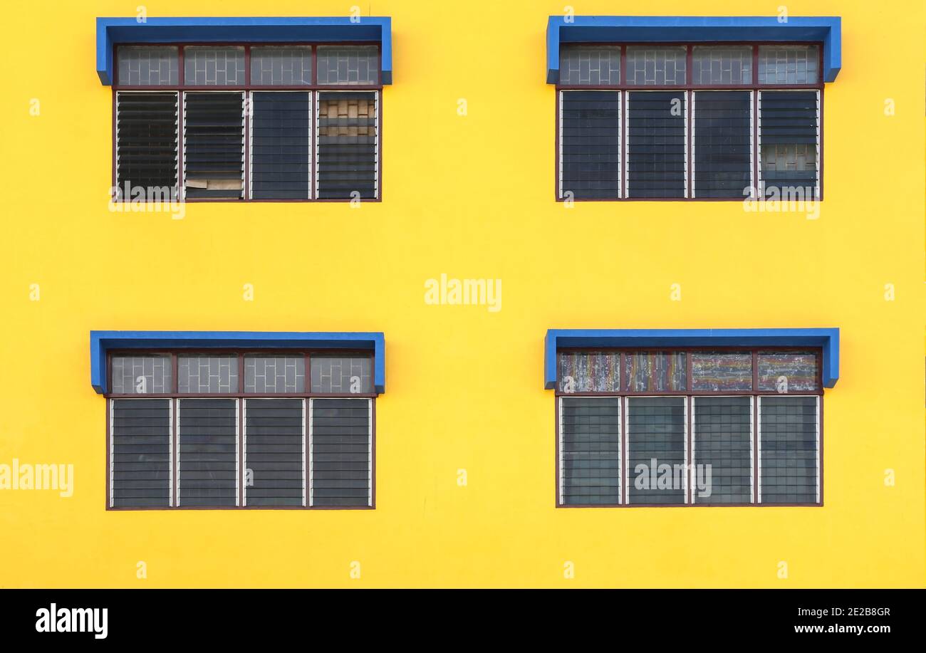 4 windows with a yellow background and painted blue windows Stock Photo ...