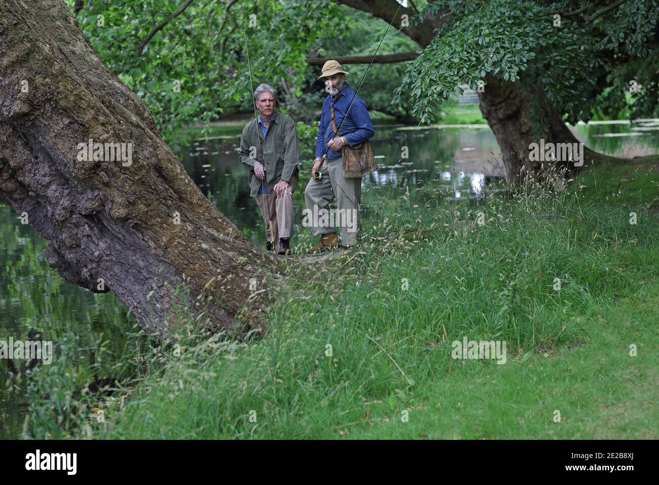 Two male friends fishing together Stock Photo - Alamy
