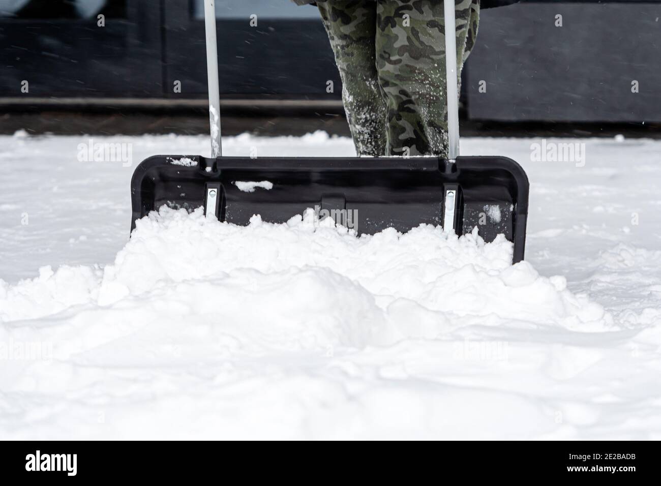 man shoveling snow in a backyard after a blizzard, close-up Stock Photo ...