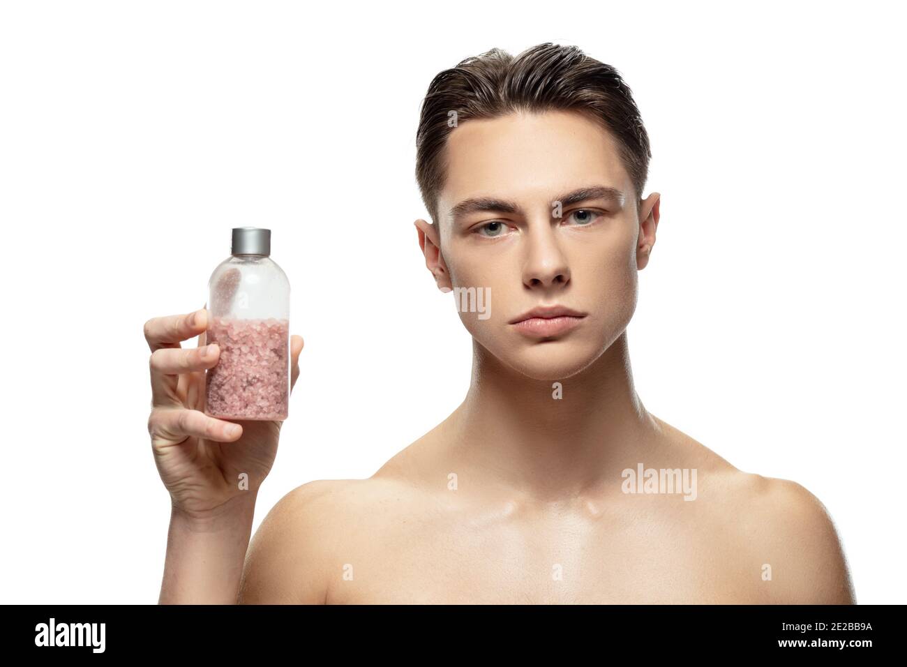Sea salt. Portrait of young man isolated on white studio background ...